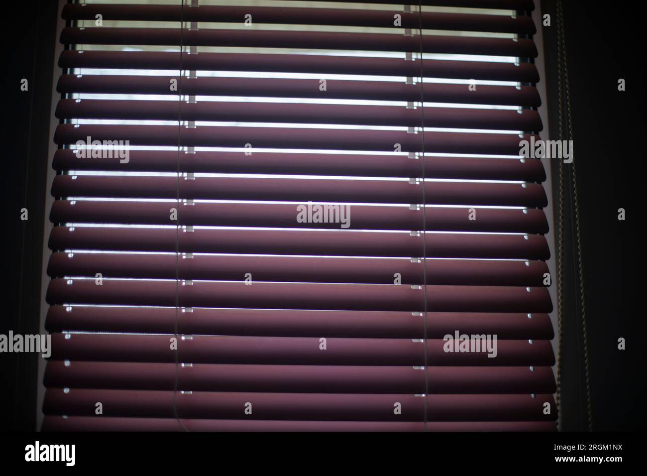 Blinds on window. Window in apartment. Closed blinds. Light through ...