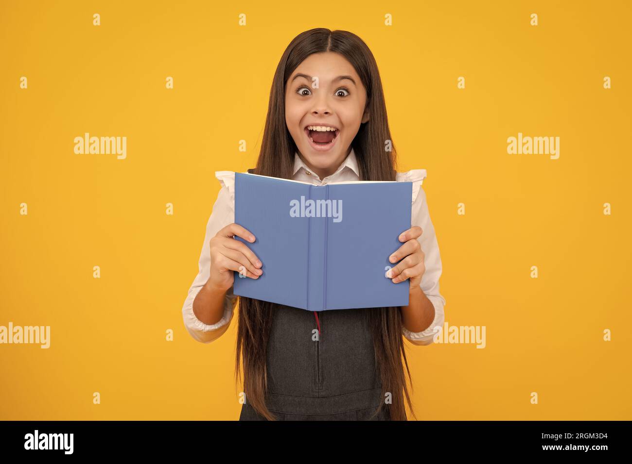 Amazed teen girl. Schoolgirl with copy book posing on isolated ...