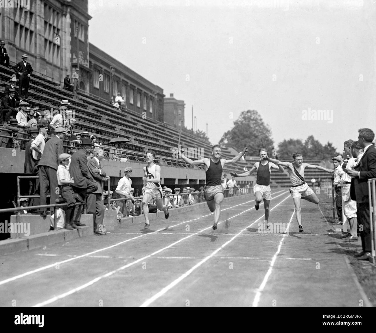 High school track meet at Central Stadium, male runners crossing the ...