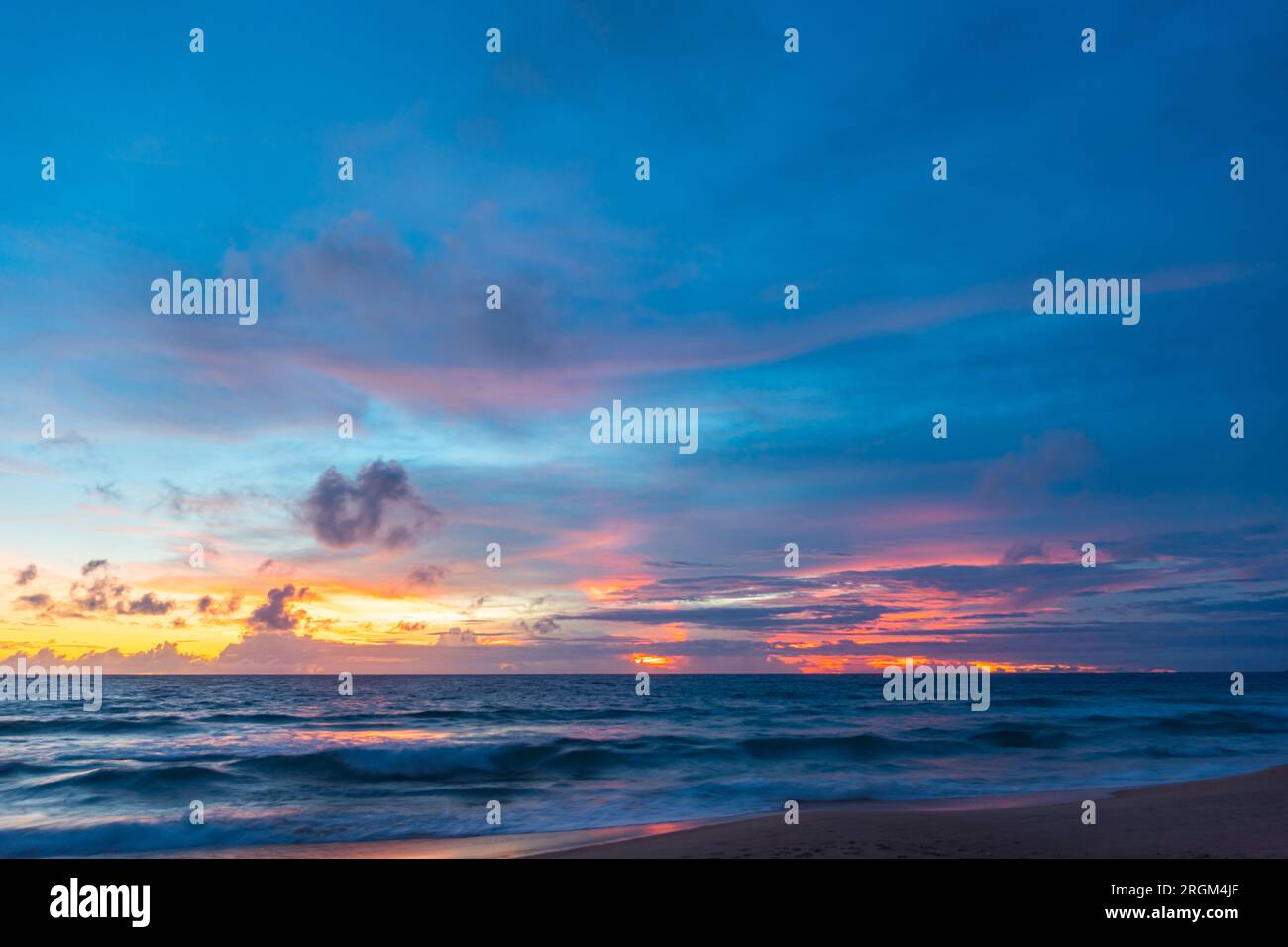 Scene of colorful pink light trough in the sky above the ocean. Scene ...