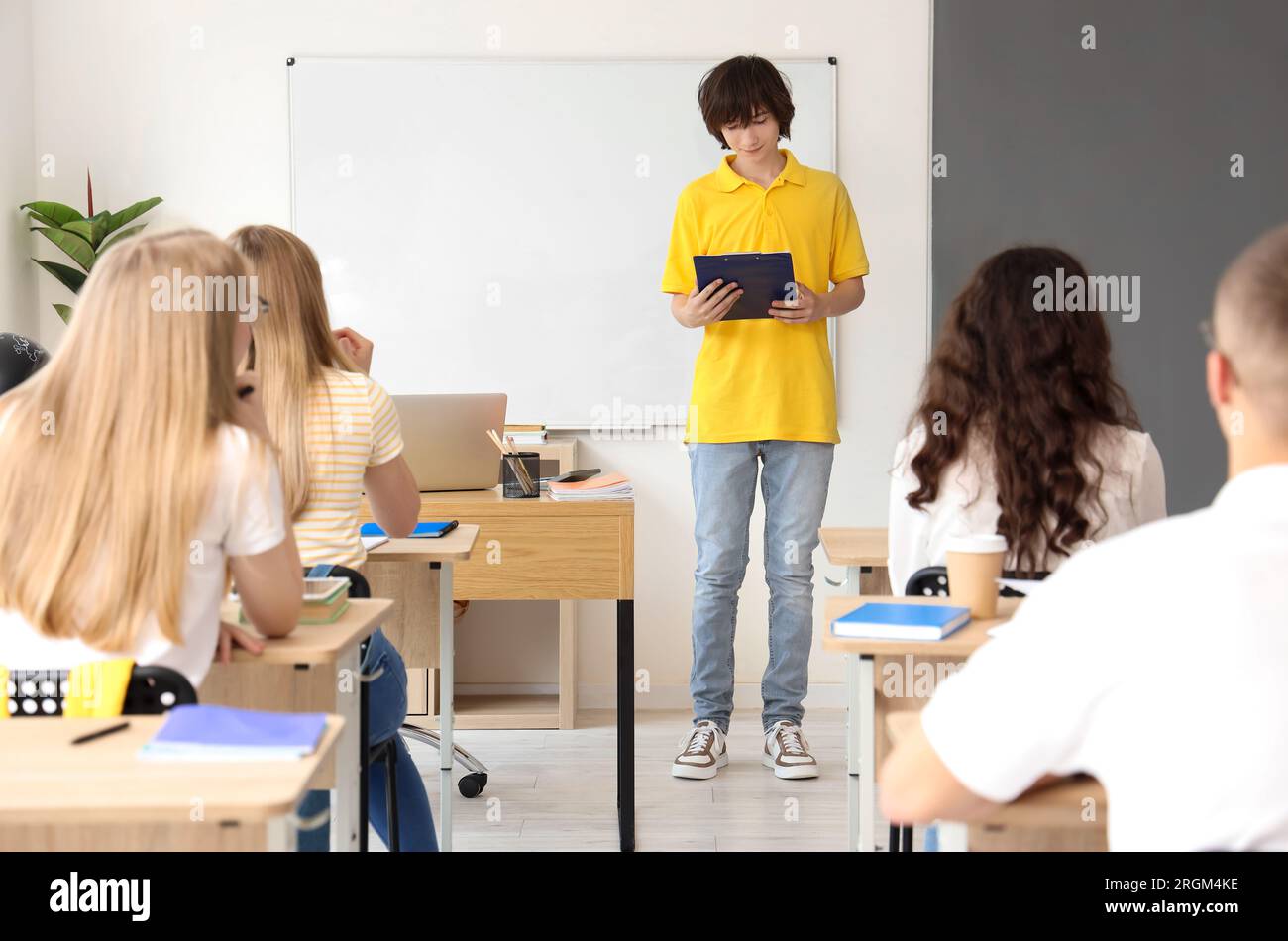 Group of students having lesson in classroom Stock Photo - Alamy