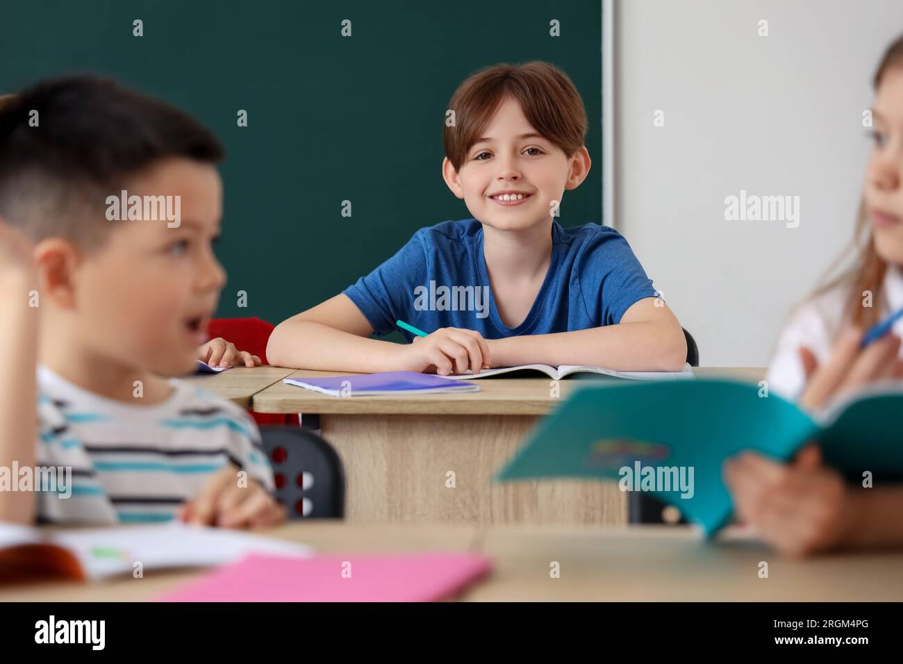 Little schoolboy having lesson in classroom Stock Photo - Alamy