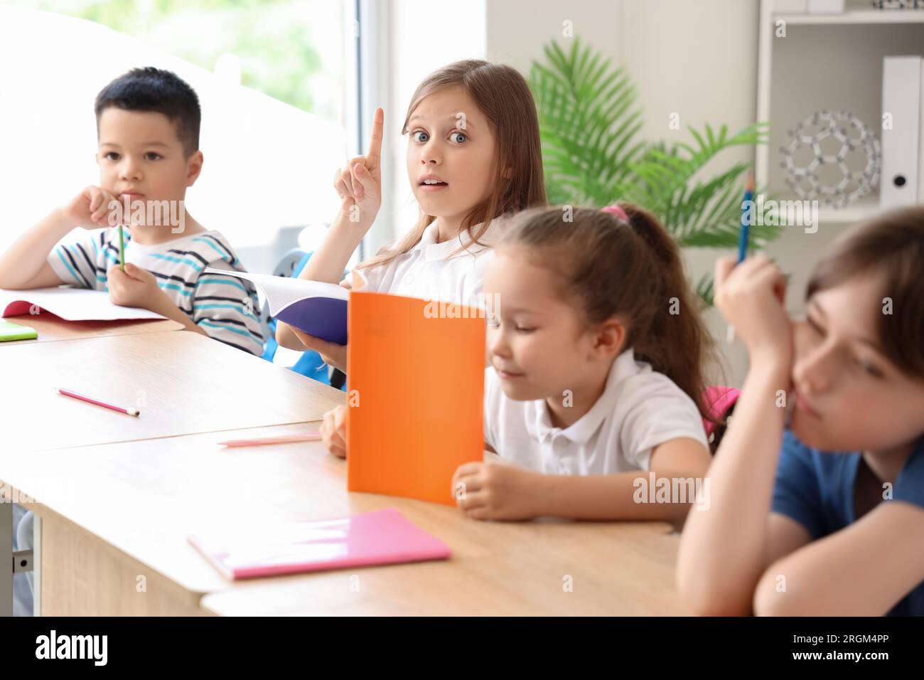 Little pupils having lesson in classroom Stock Photo - Alamy
