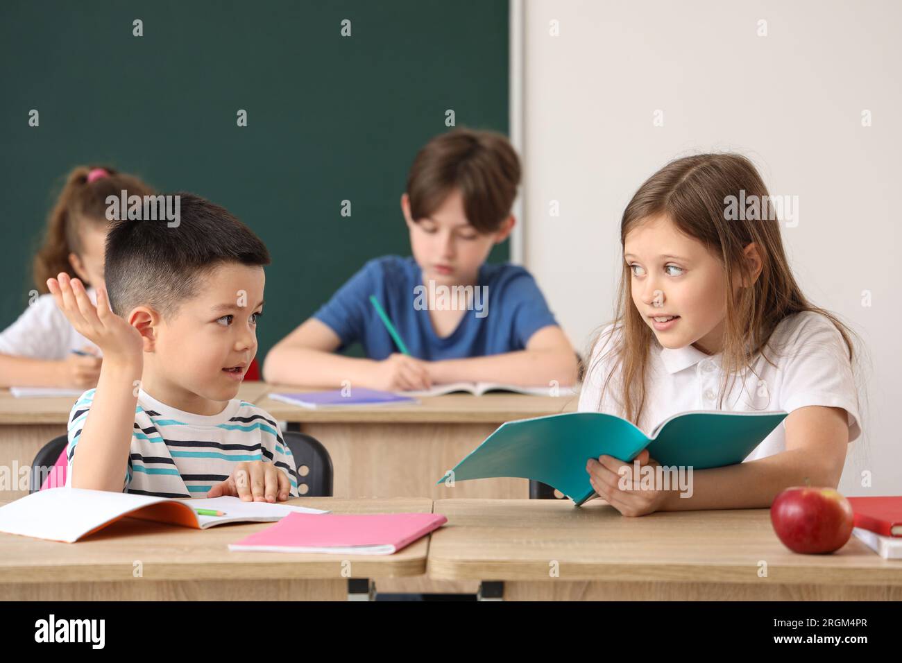 Little pupils having lesson in classroom Stock Photo - Alamy