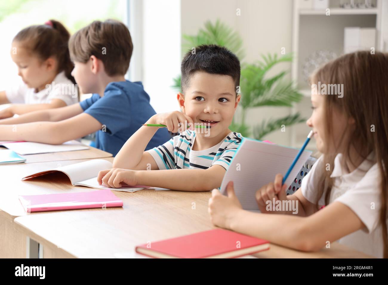Little schoolboy having lesson in classroom Stock Photo - Alamy