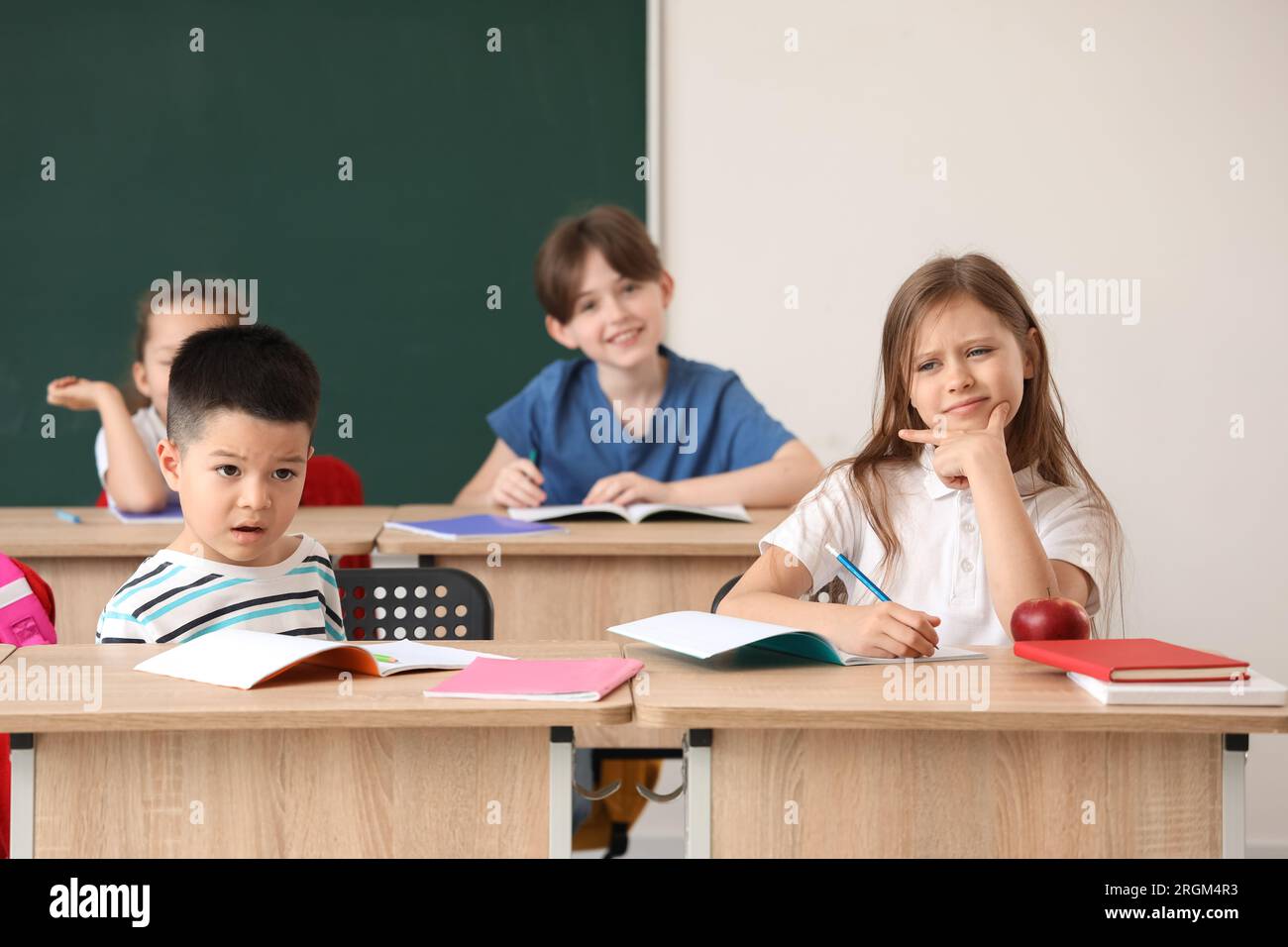 Little pupils having lesson in classroom Stock Photo - Alamy