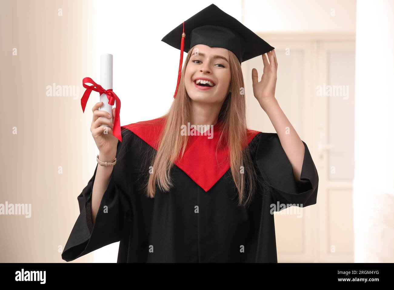 Female graduate student with diploma in hall Stock Photo - Alamy