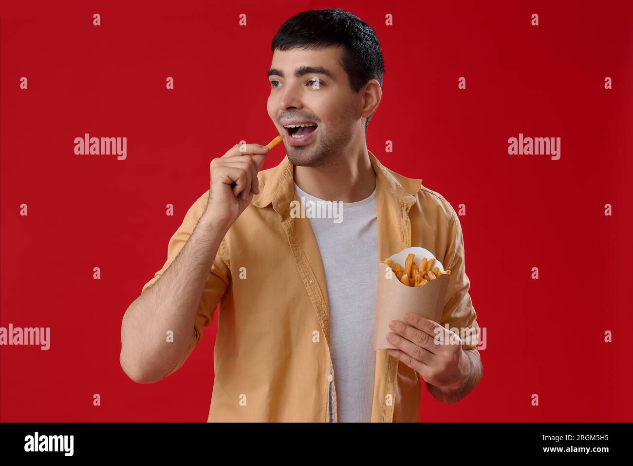 Man eating french fries hi-res stock photography and images - Alamy