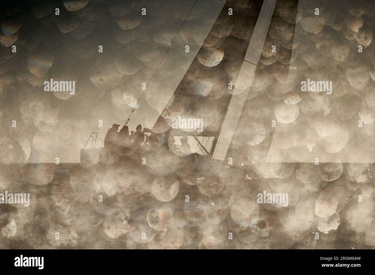 The view through the spray of how the sailboat is heeling at sunset ...