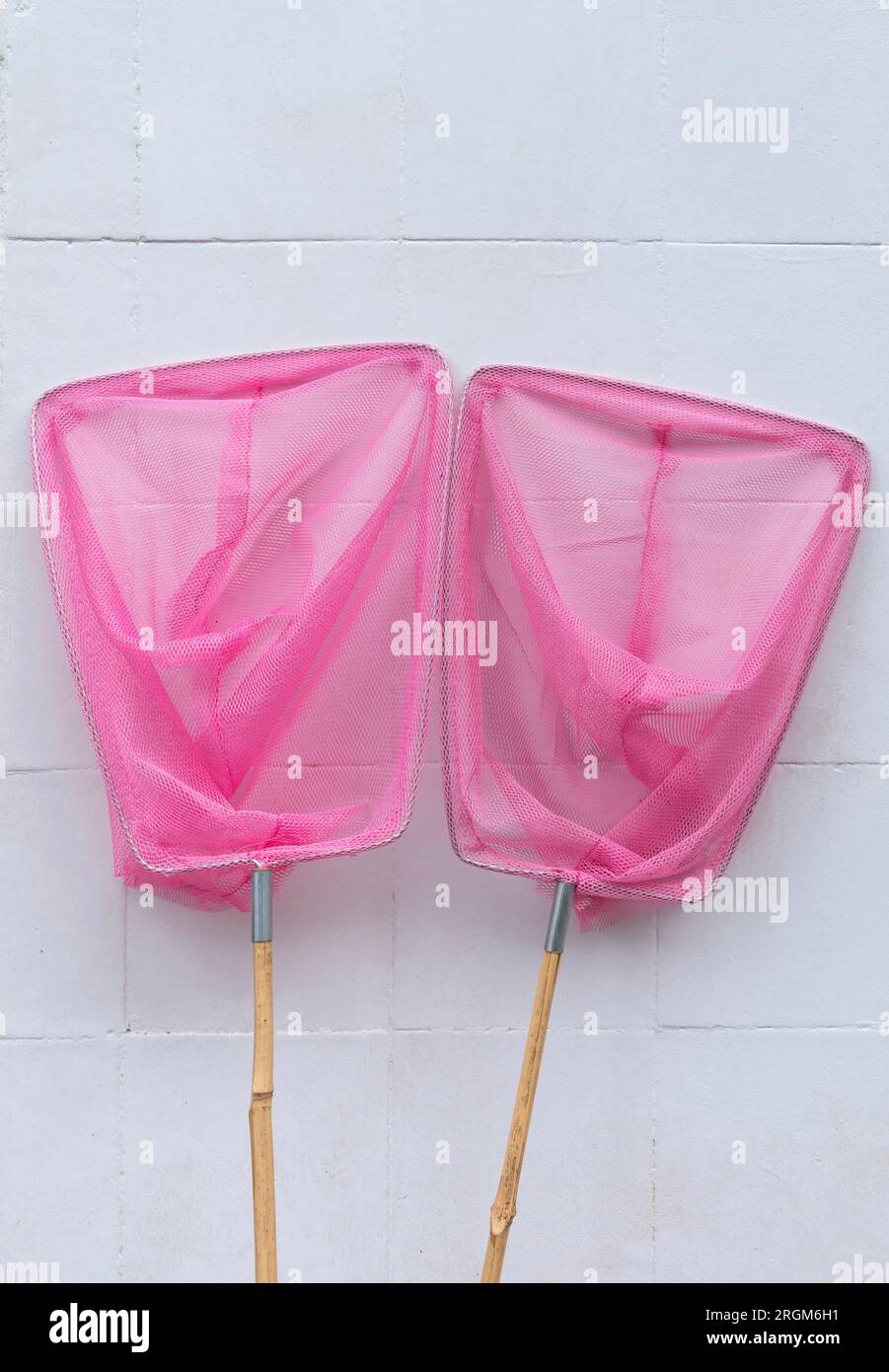 Pink fishing nets for kids Stock Photo - Alamy