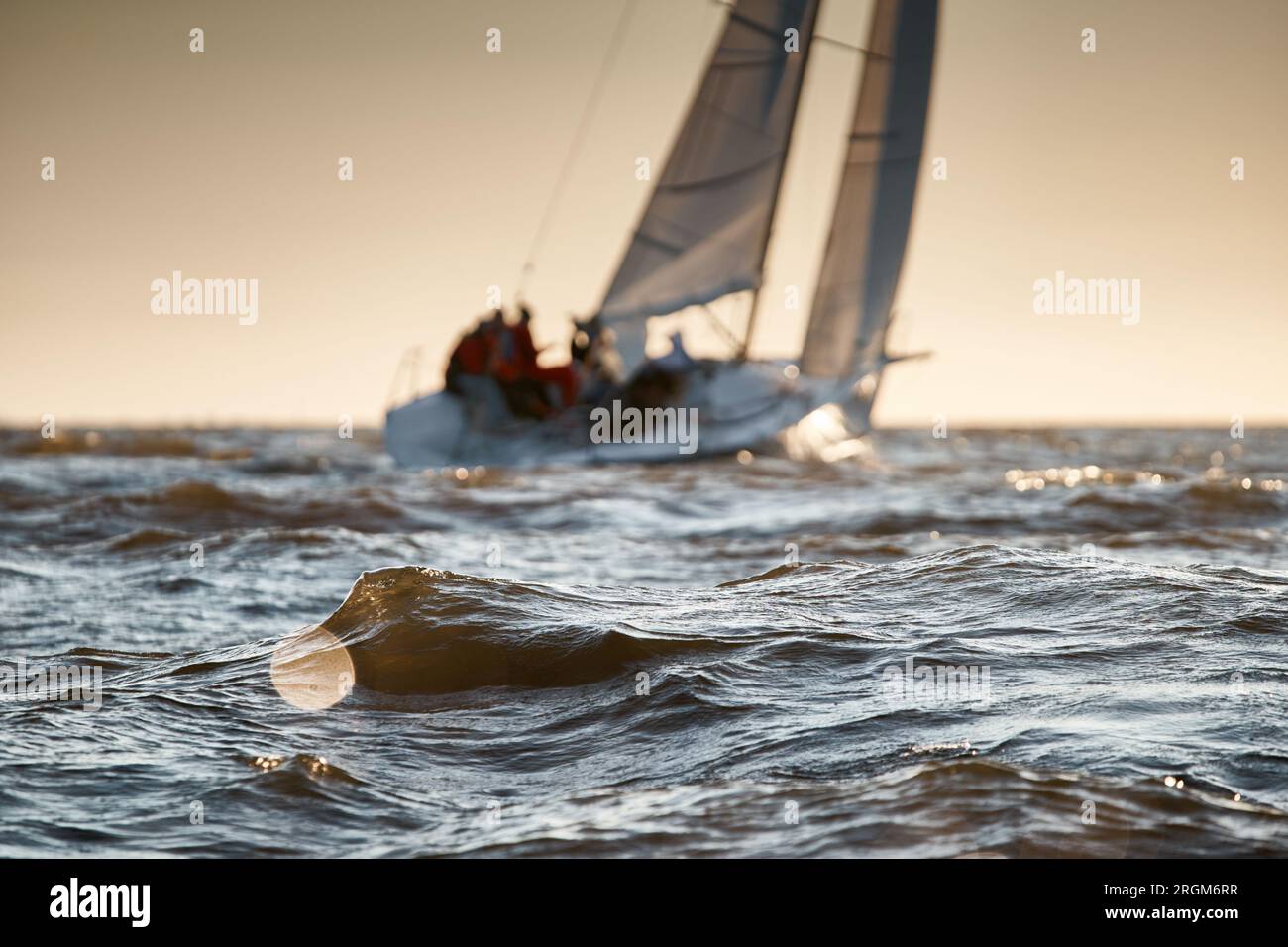 The view through the spray of how the sailboat is heeling at sunset ...