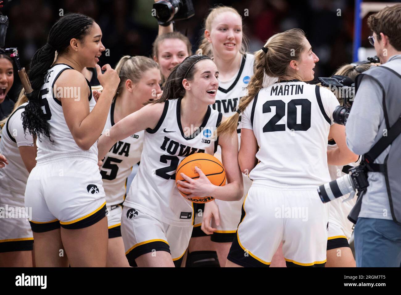 FILE - Iowa players, including guard Caitlin Clark, front center ...