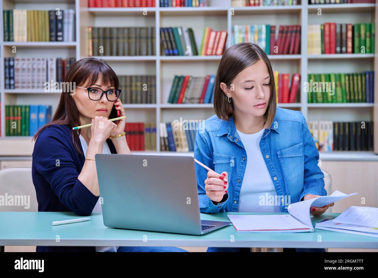 Female university student with teacher preparing for exam, inside ...