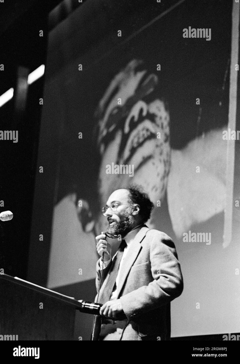 Speaking against a slide projection showing the face of a victim of the ...