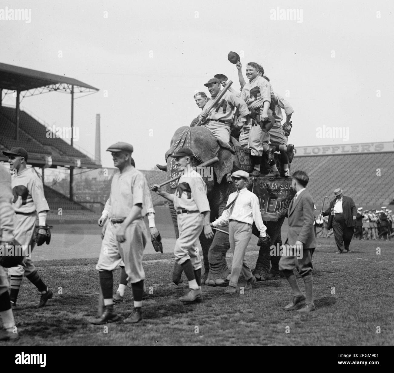 Members of the Republican baseball team ride on the ball field on top ...