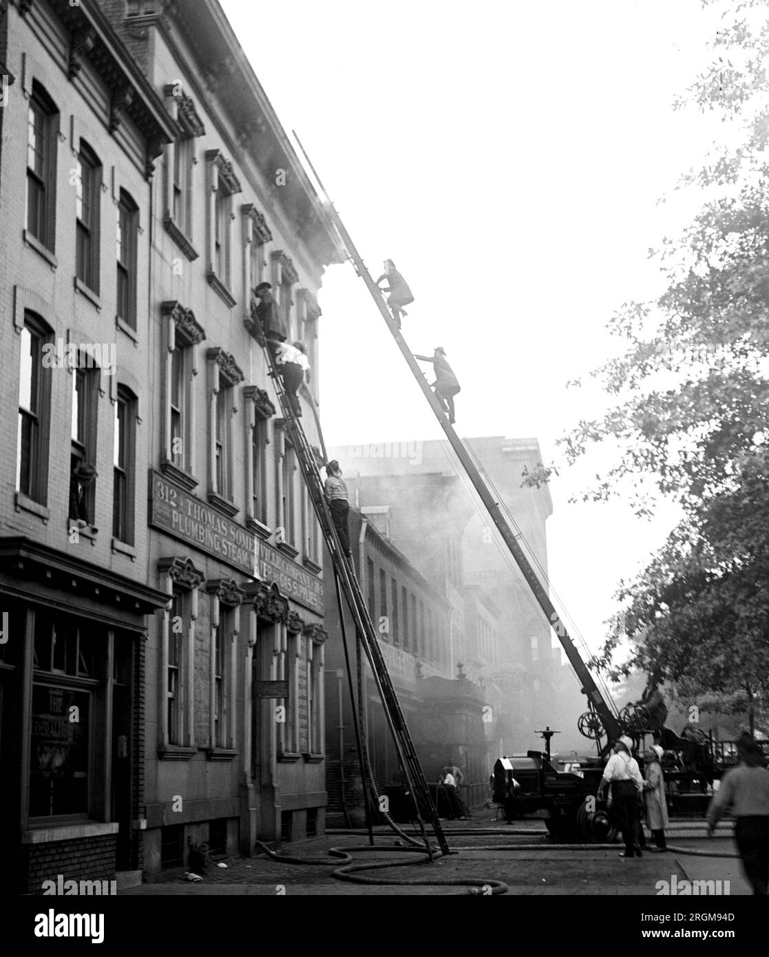 Firemen fighting a fire at Thomas Sommerville plant ca. 1926 Stock ...