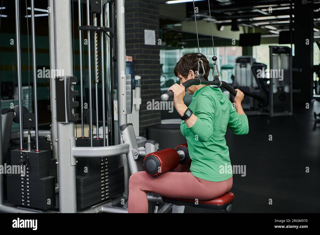 strong and motivated elderly woman working out in gym, mature fitness ...