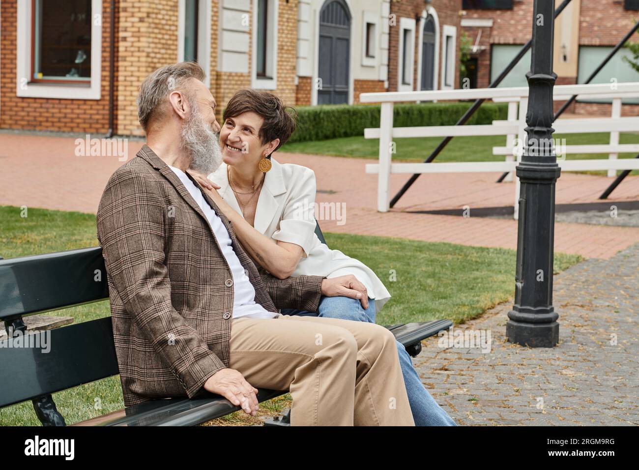 happy elderly woman looking at bearded man, romance, husband and wife ...