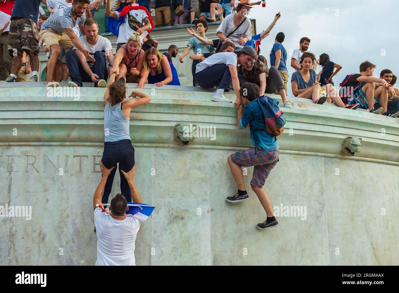 Paris, France, 2018. People helping a young woman and a young man get ...