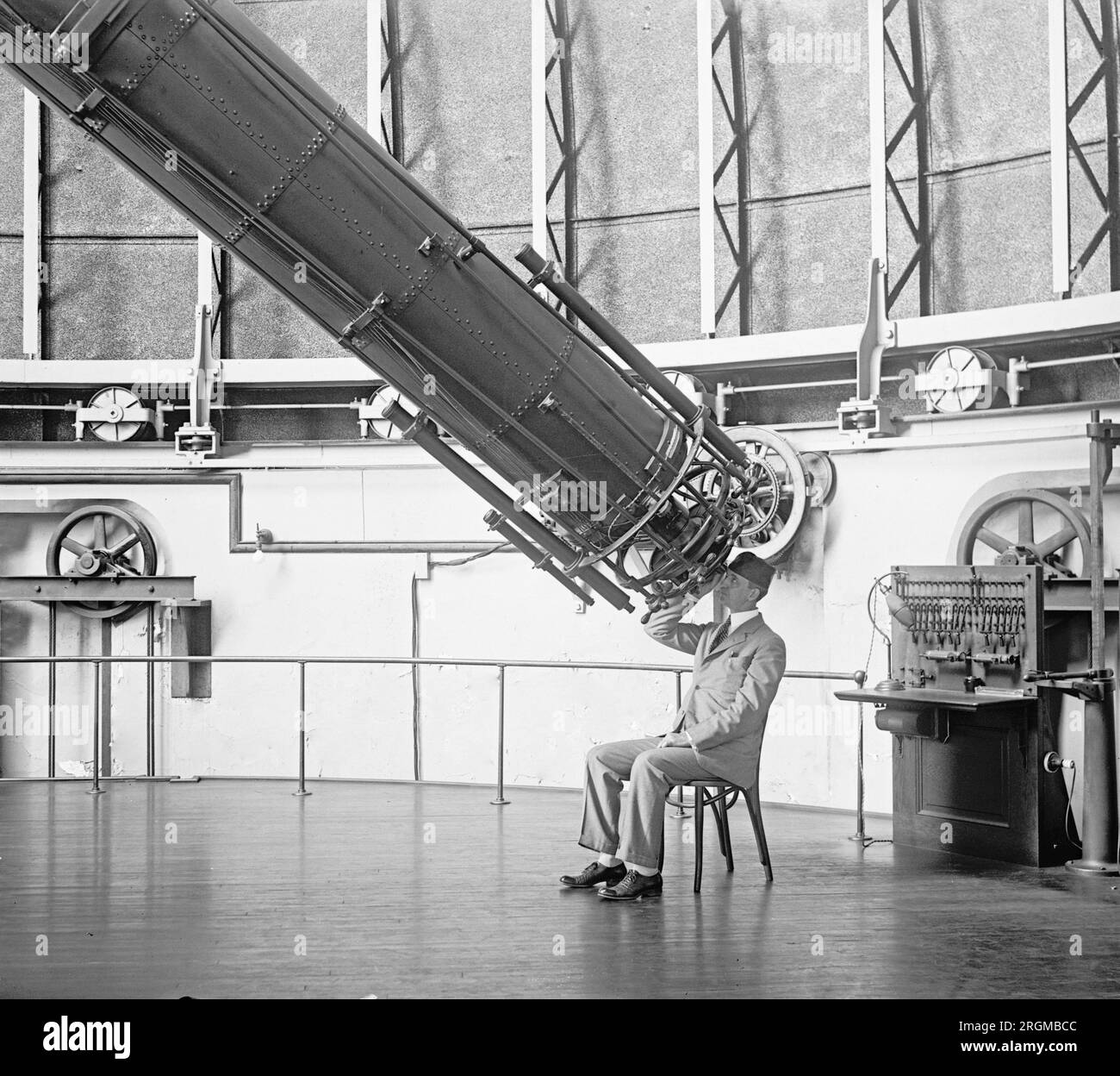 Man looking through a large telescope at an observatory ca. 1929 Stock ...