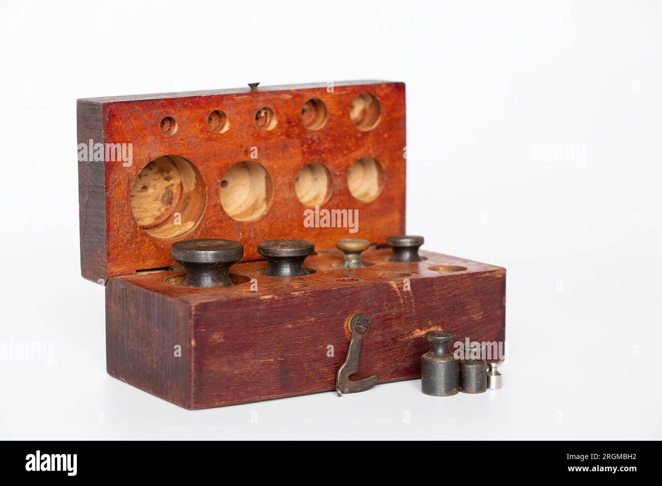 Old rusty weights for scales of different sizes and scales in a wooden ...