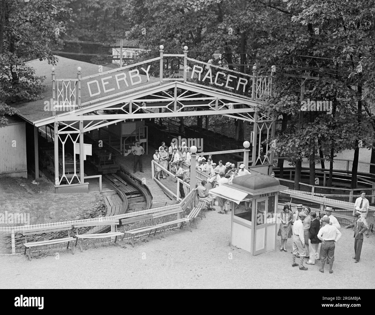 Park visitors stand in line to ride the Derby Racer ride at Glen Echo ...