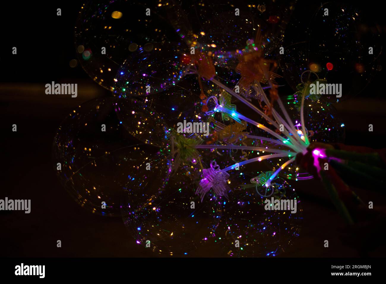 Colored balls in dark. LED Light. Transparent ball with colored lights ...