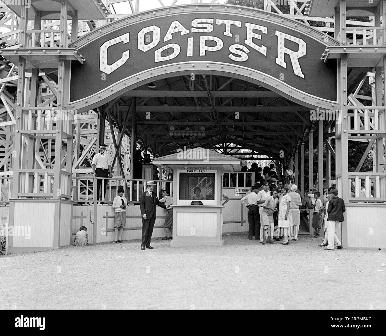 Park visitors wait in line to ride the Coaster Dips roller coaster at ...