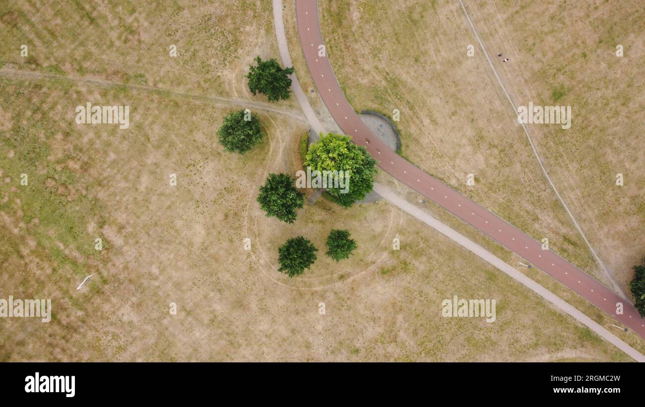 The bike path crosses the field in the city Stock Photo - Alamy