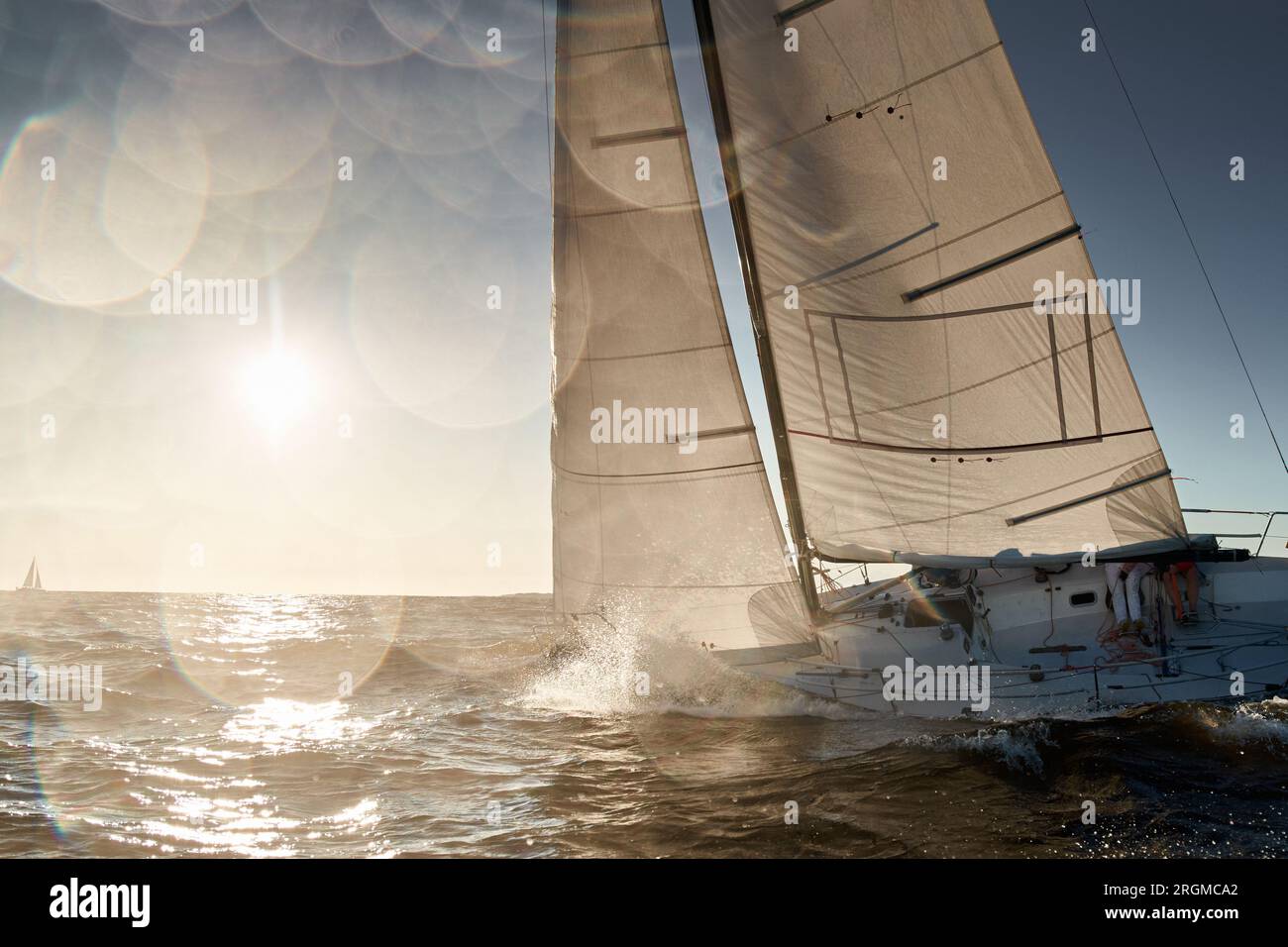 The view through the spray of how the sailboat is heeling at sunset ...