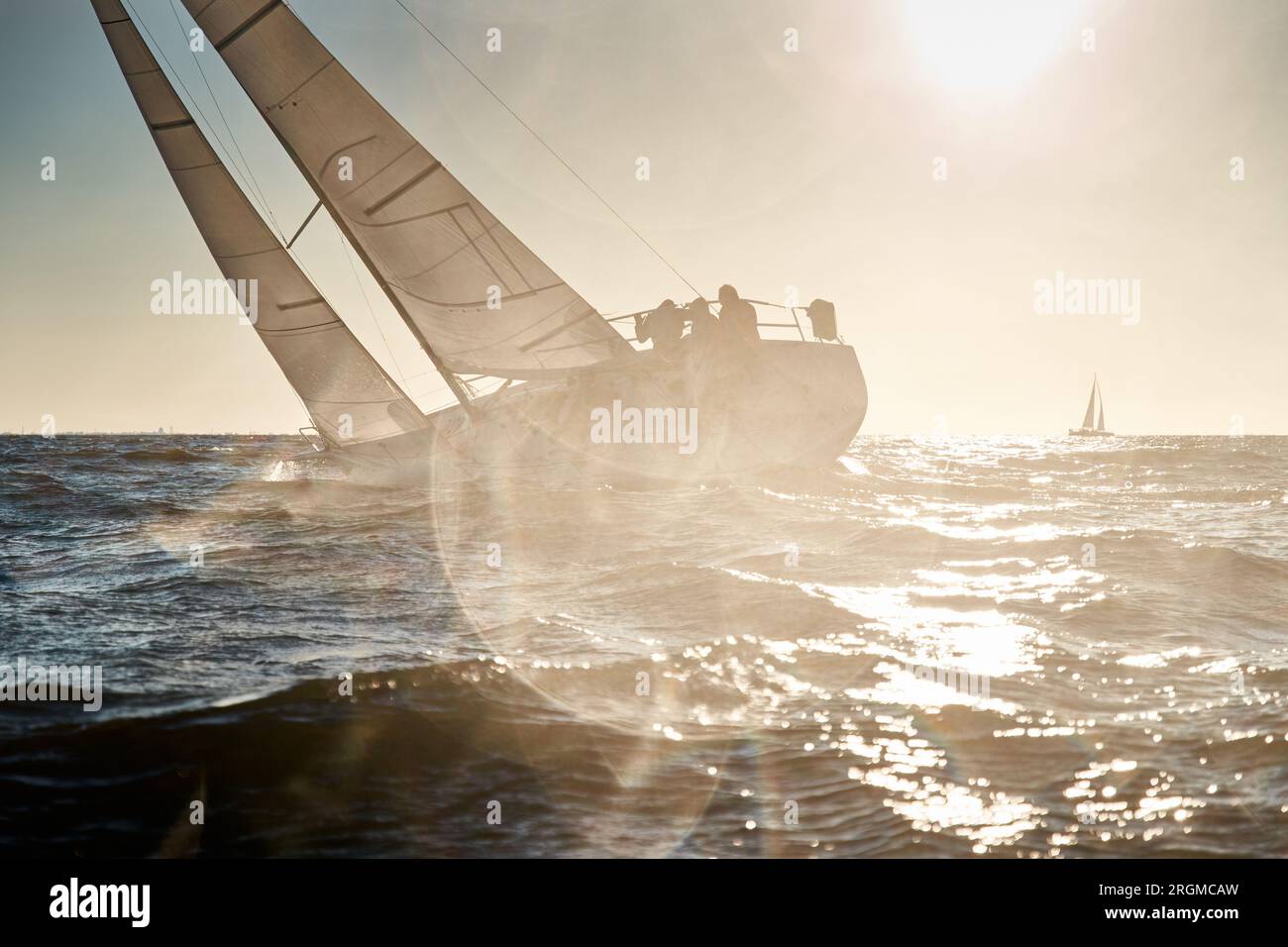 The view through the spray of how the sailboat is heeling at sunset ...