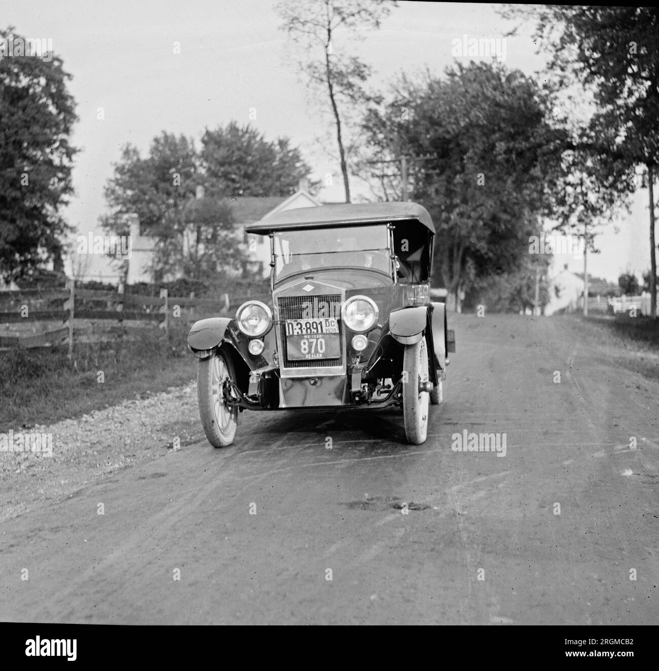 Vintage car driving down a road ca. 1920 Stock Photo - Alamy