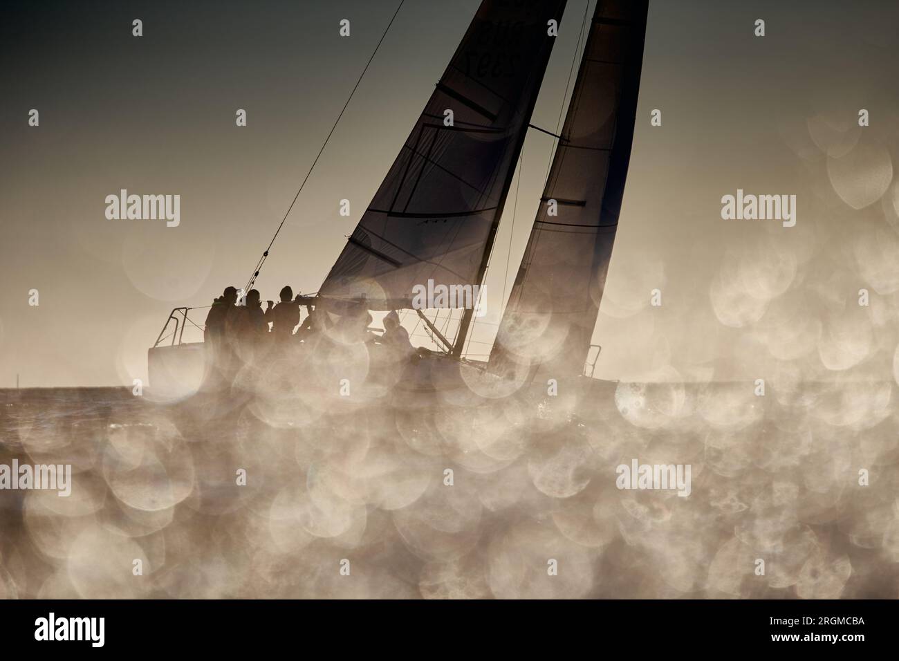 The view through the spray of how the sailboat is heeling at sunset ...