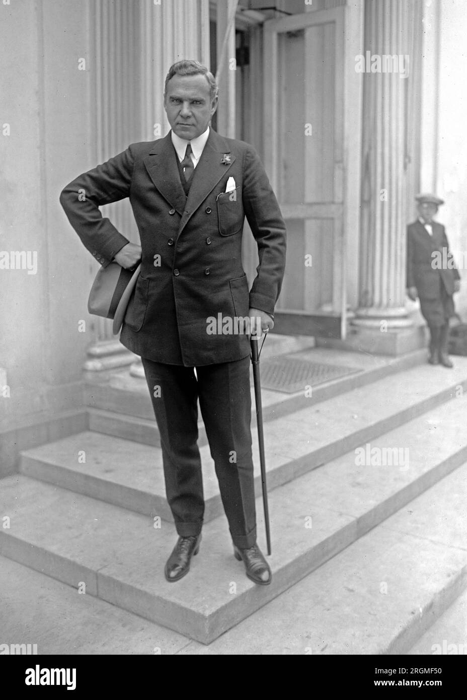 Industrialist Matthew C. Brush standing outdoors with a walking stick ...