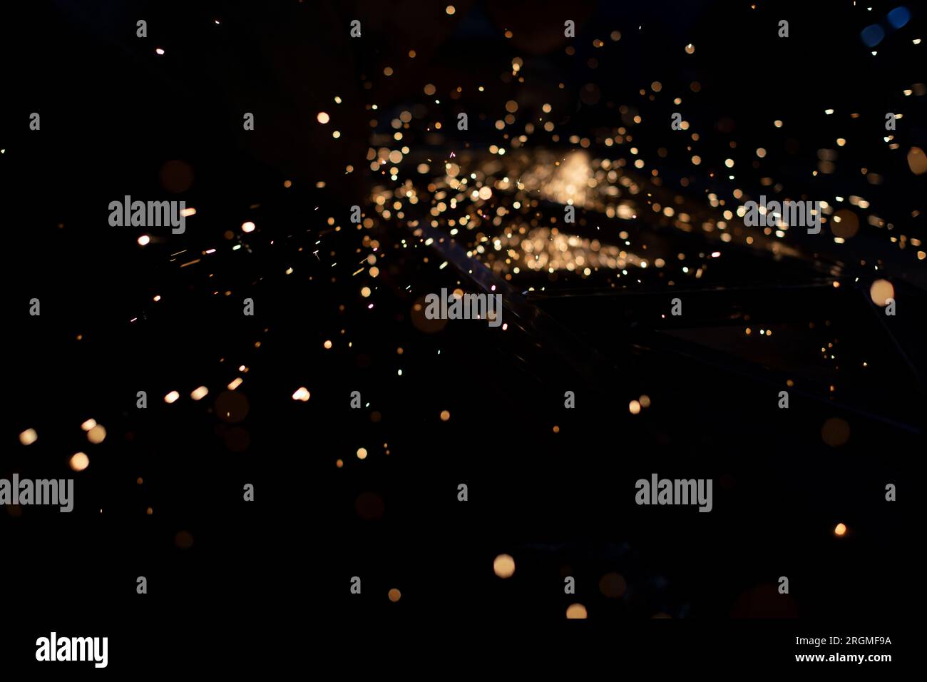 Metal grinding. Sparks from friction. Lights in dark. Chaotic flight of ...