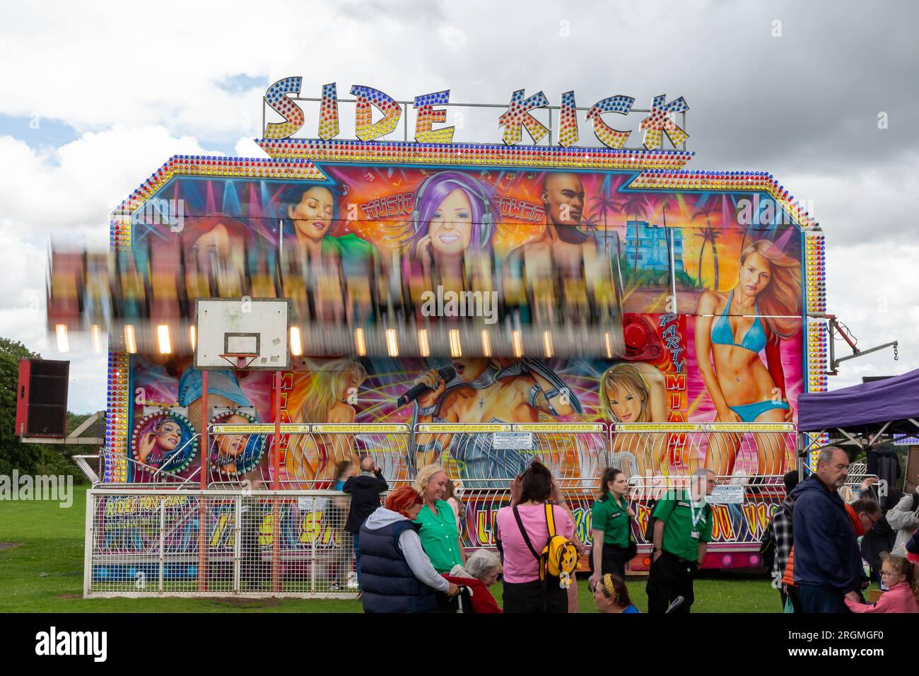 Children having fun on a moving, rotating, colourful funfair ride ...