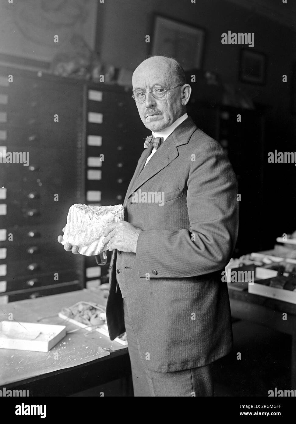 Portrait of Dr. J.W. Gidley of Smithsonian Institute with tooth of ...