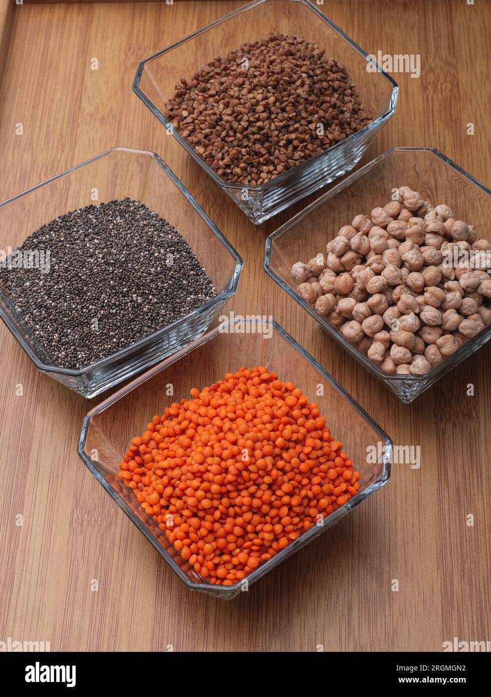 Four different types of cereals: buckwheat, nohut ,red lentils, chia ...