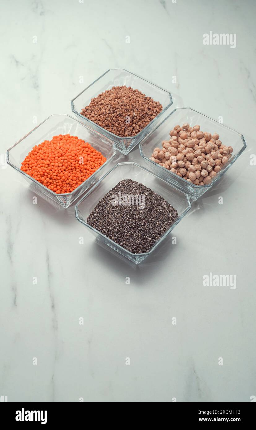 Four different types of cereals: buckwheat, nohut ,red lentils, chia ...
