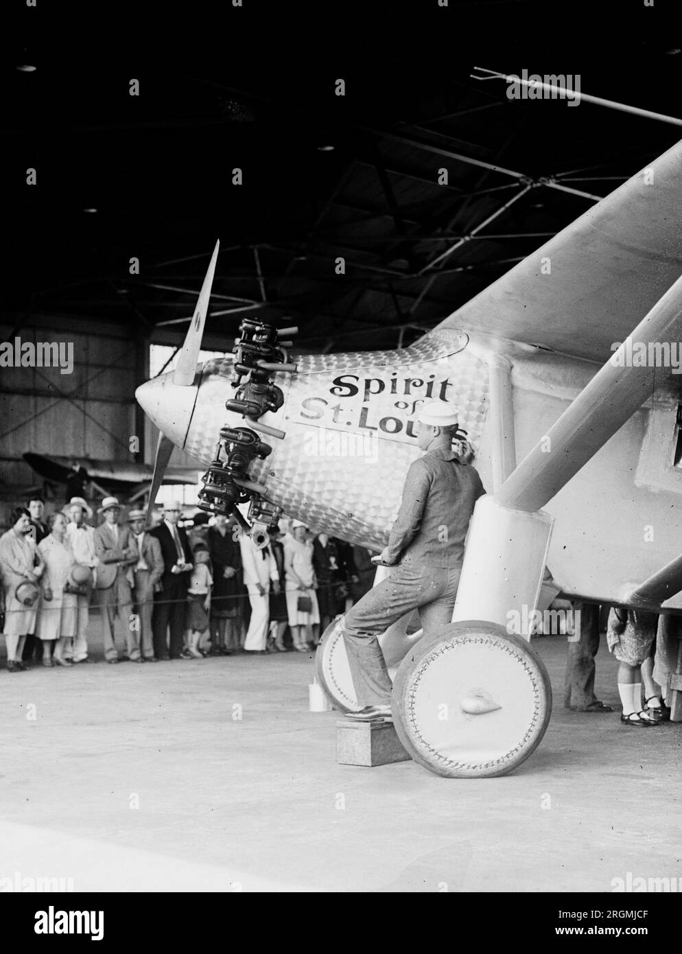 Charles Lindbergh and The Spirit of St. Louis airplane in a hangar ca ...
