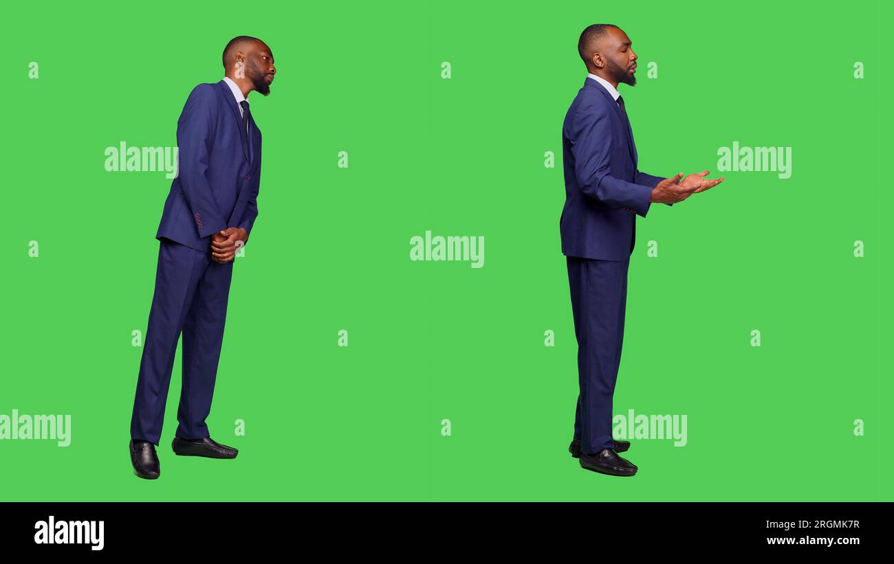 Male office worker in formal suit waiting in studio, looking around ...