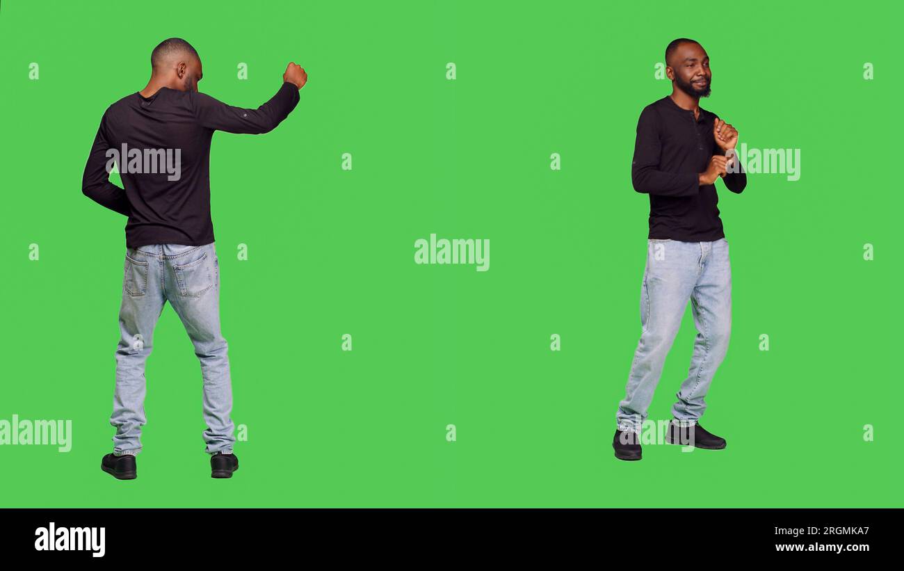 Joyful smiling man doing dance moves acting funny standing over full ...