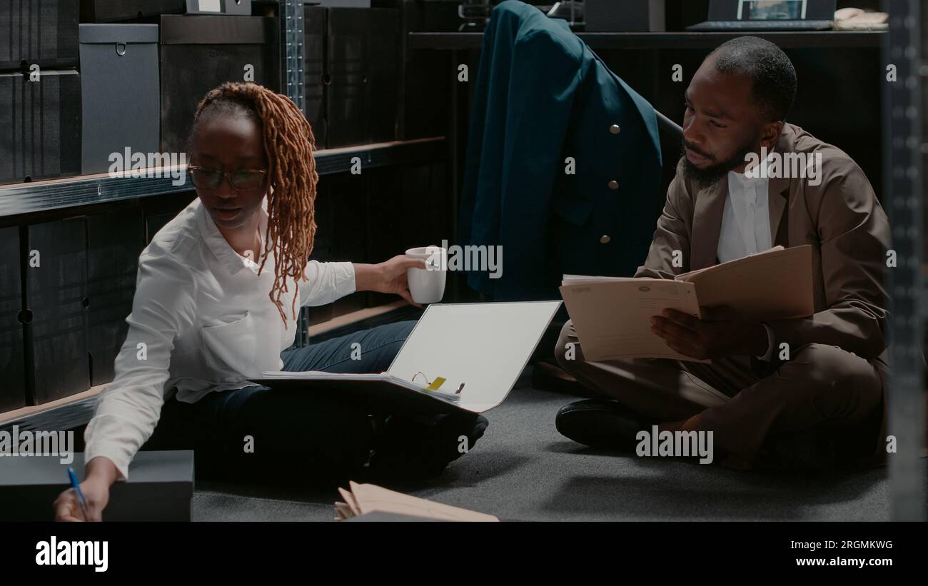 Team of colleagues examining police archive photos to solve case and ...