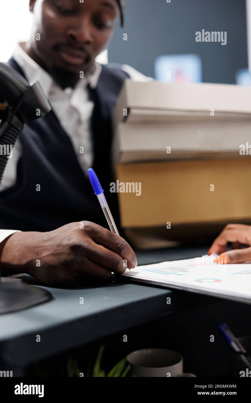African american shopper signing clothing store receipt, buying ...