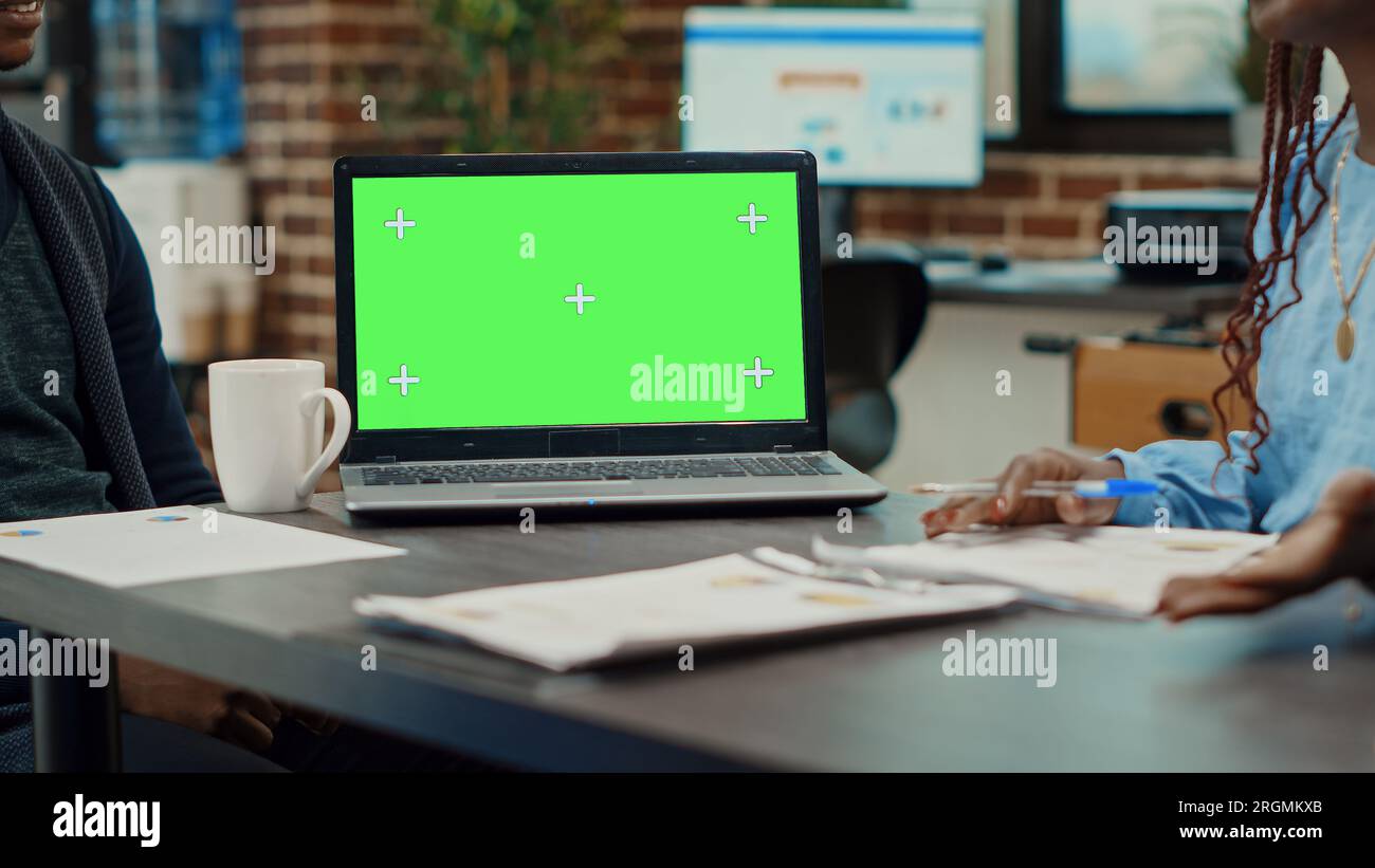 People having laptop with greenscreen on desk, talking about ...