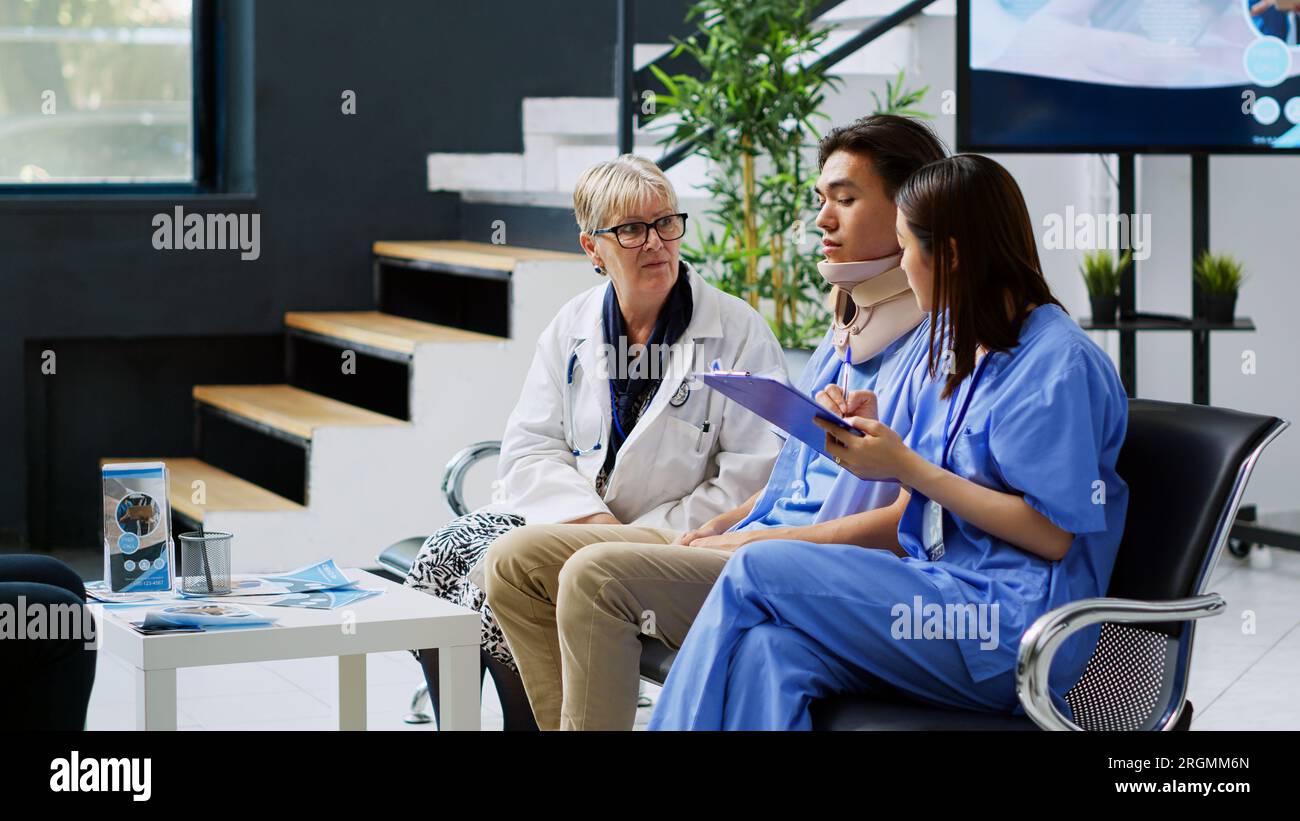 Medic discussing with injured patient to remove neck collar during ...