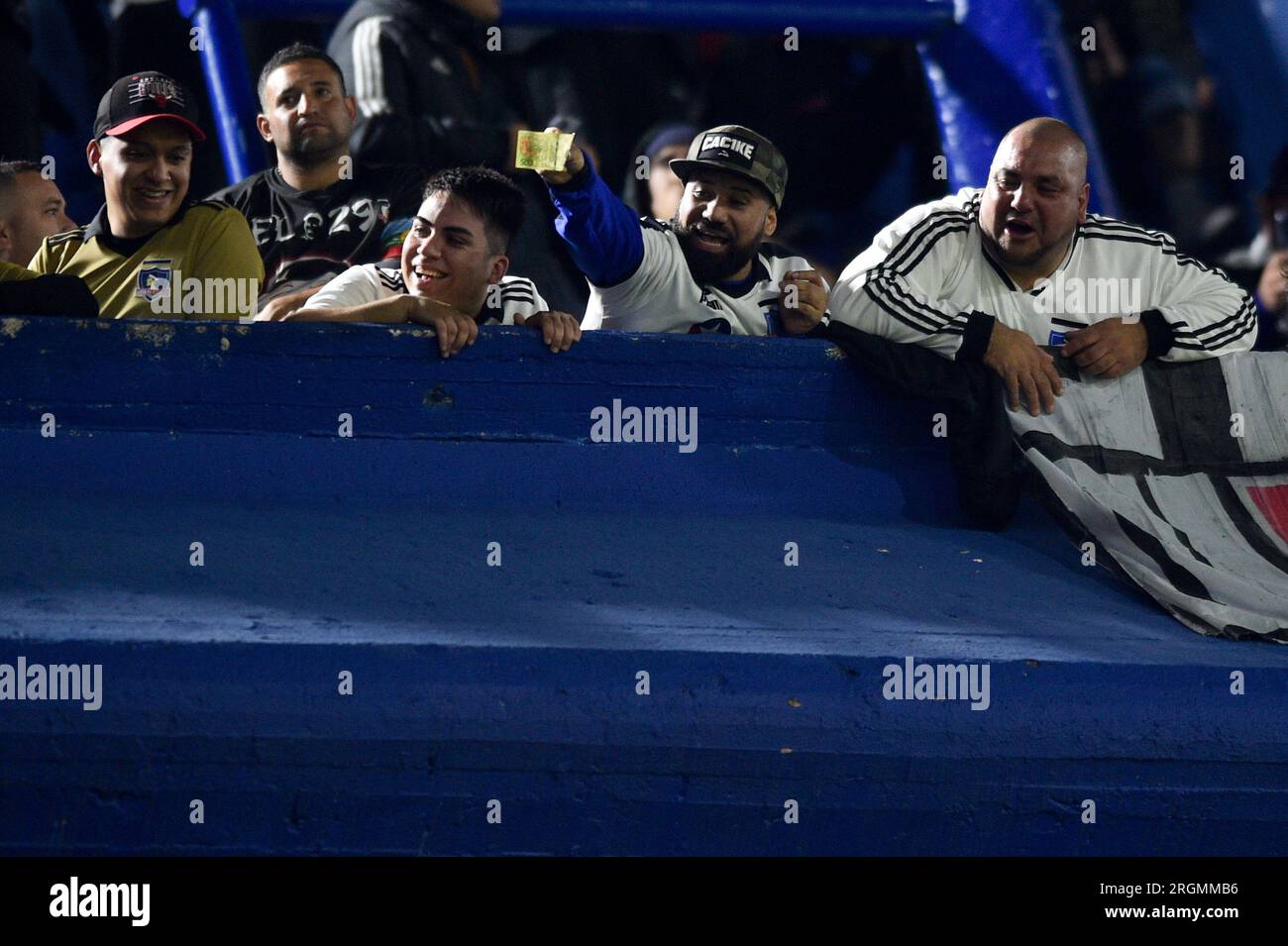FILE - A Chile's Colo-Colo soccer fan holds out Argentine banknotes ...
