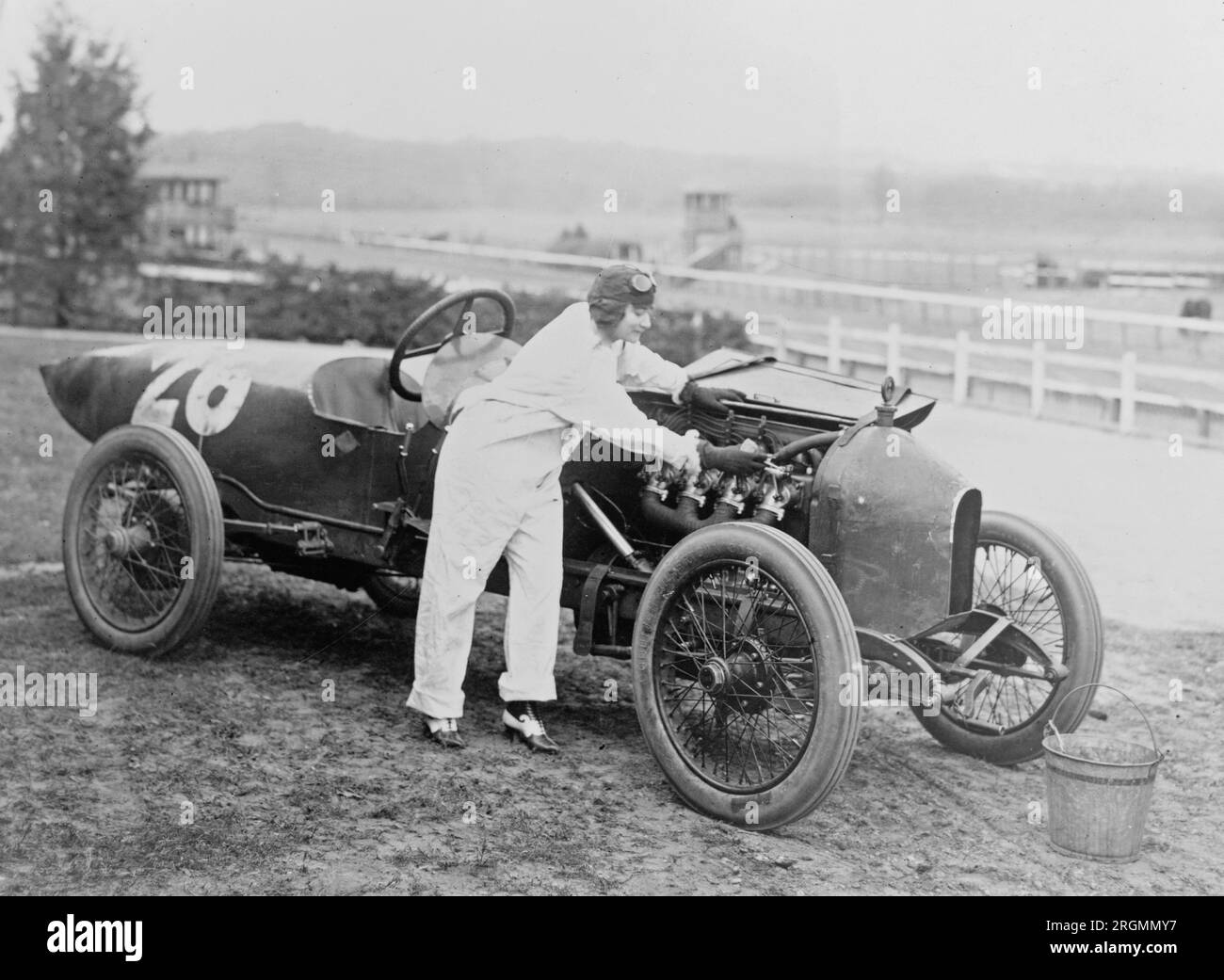 Vintage Auto Racing: Woman working under hood of Stutz Weightman ...