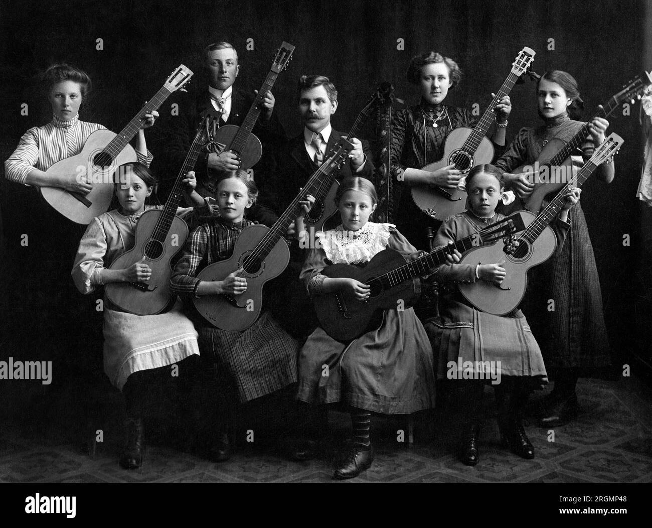 Portrait of a Group of Young Musicians with Acoustic Guitars, Cabinet ...