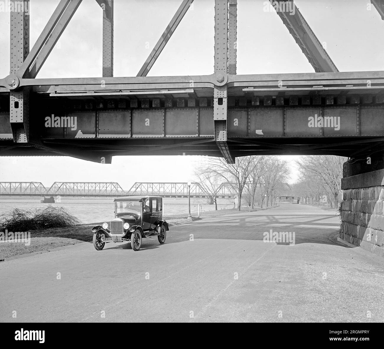 Ford Automobile driving under a steel bridge ca. 1910-1926 Stock Photo ...